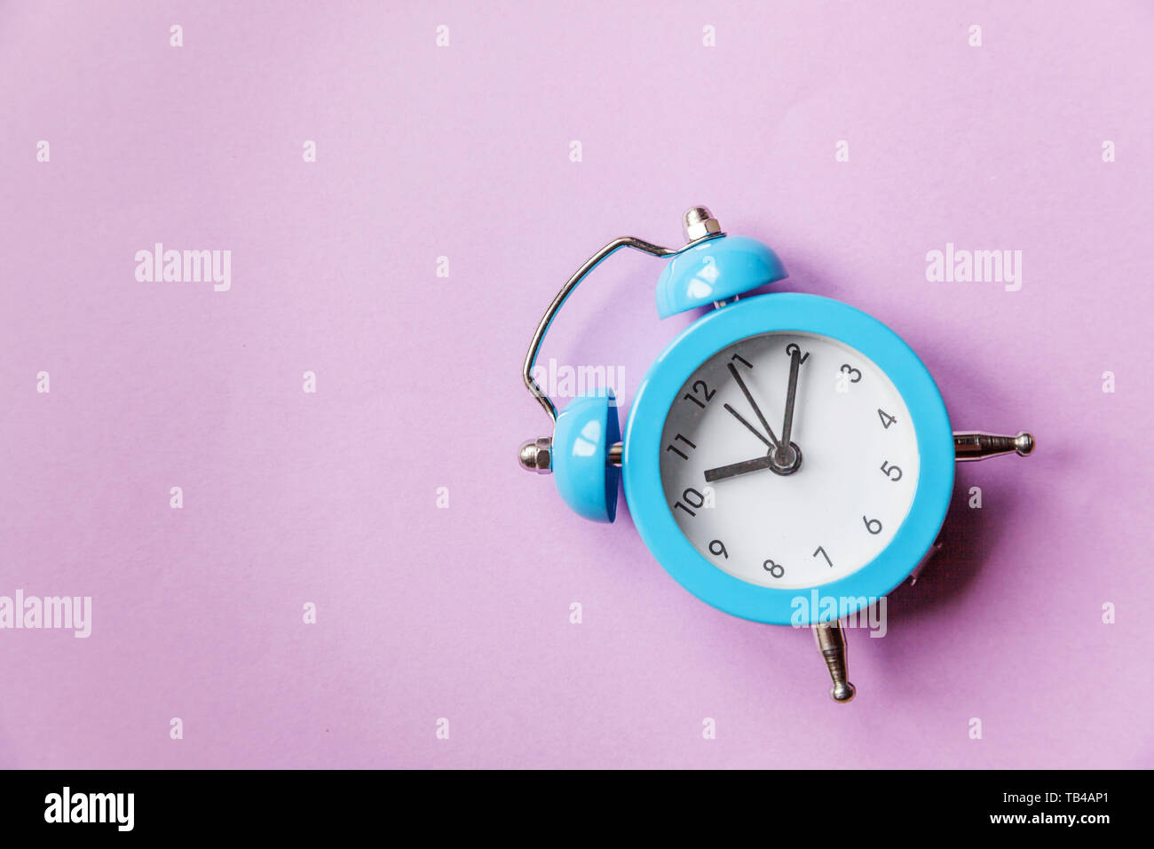Ringing twin bell vintage classic alarm clock Isolated on purple violet ...