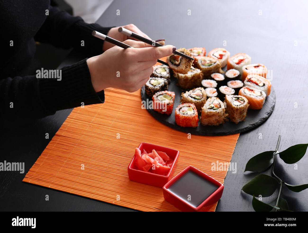 Young woman eating sushi rolls hi-res stock photography and images - Alamy