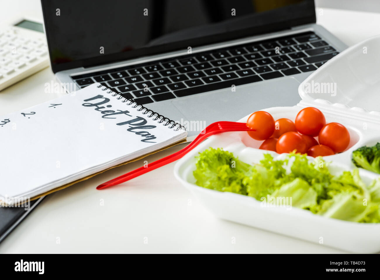 tasty vegetables near notebook with diet plan lettering and laptop ...