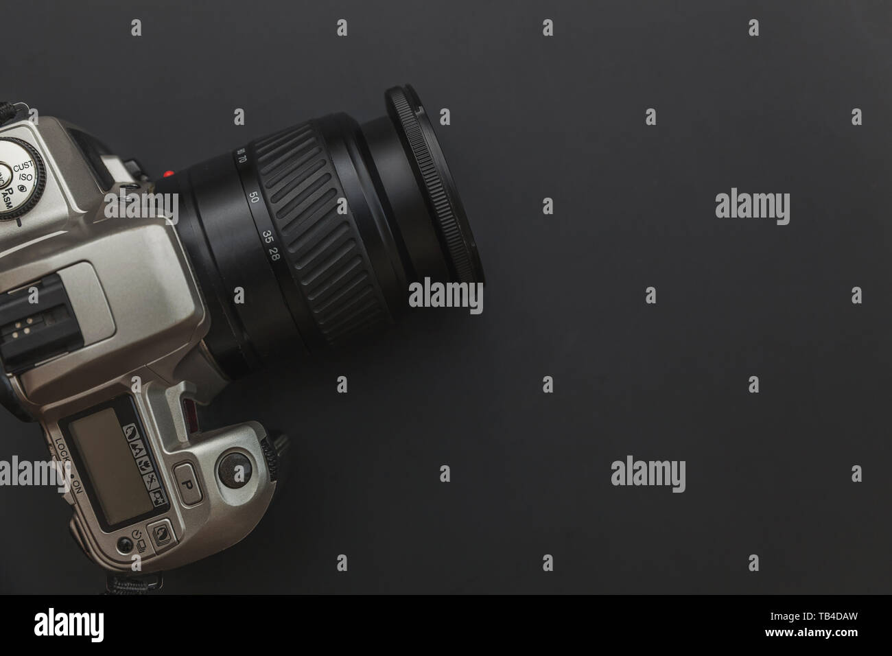 Photographer workplace with dslr camera system on dark black table ...