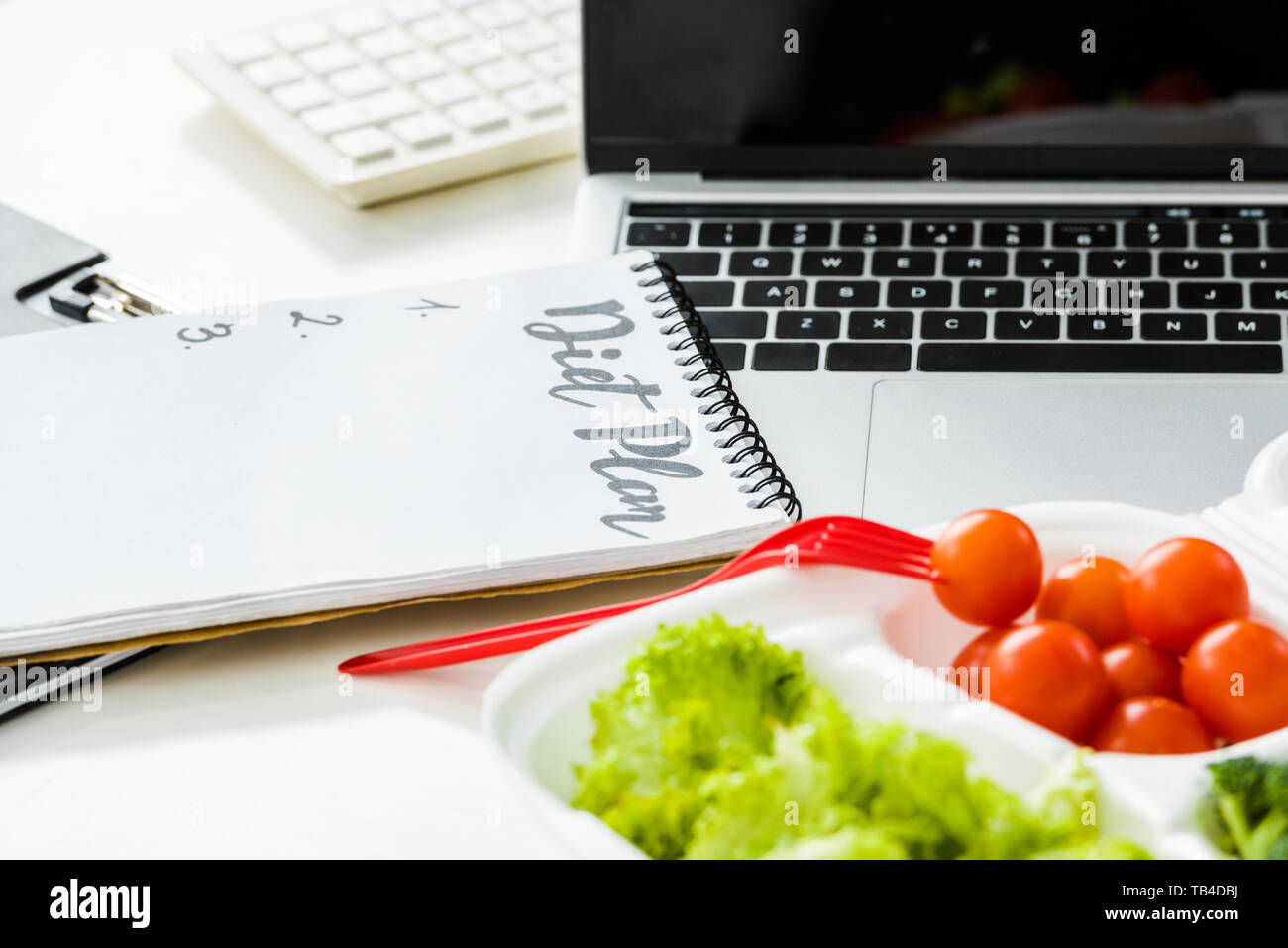 organic vegetables near notebook with diet plan lettering and laptop ...