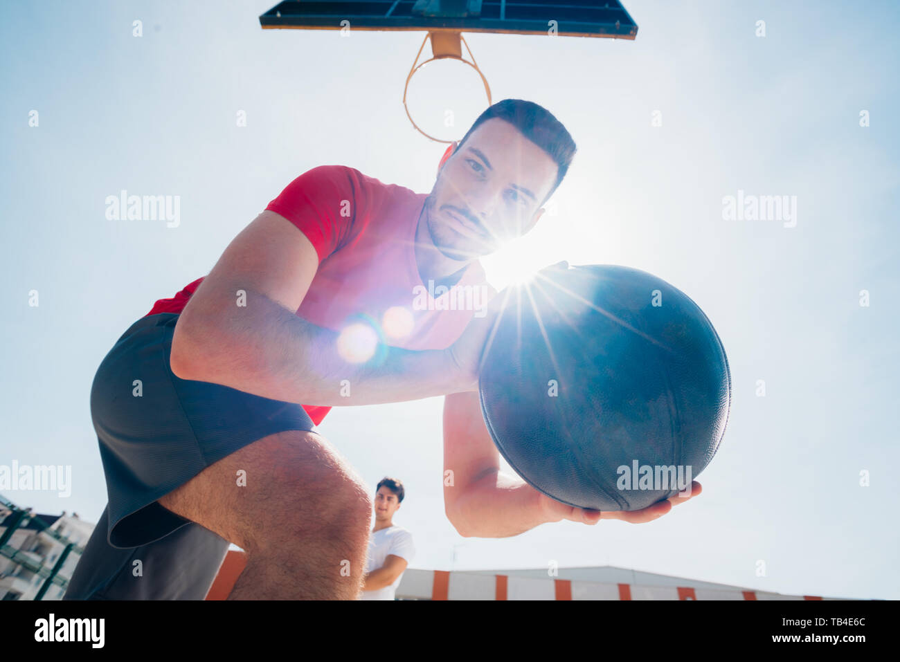 Close up portrait of two basketball players while the push each other ...