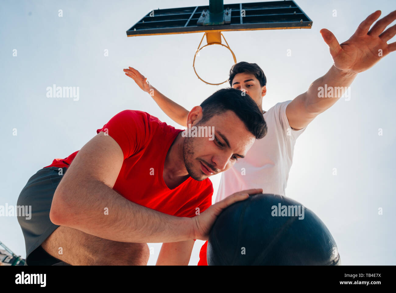 Close up portrait of two basketball players while the push each other ...