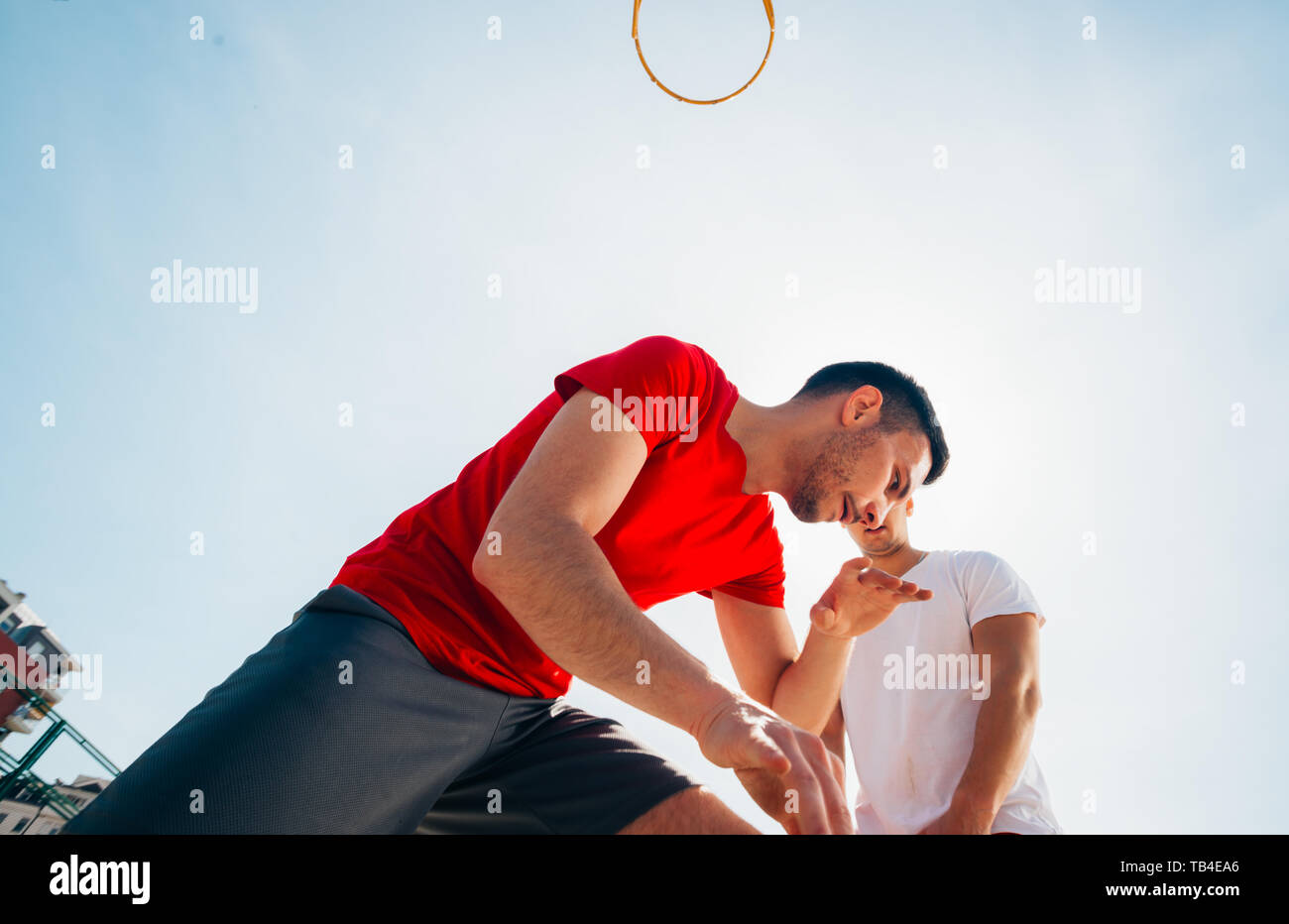 Close up portrait of two basketball players while the push each other ...
