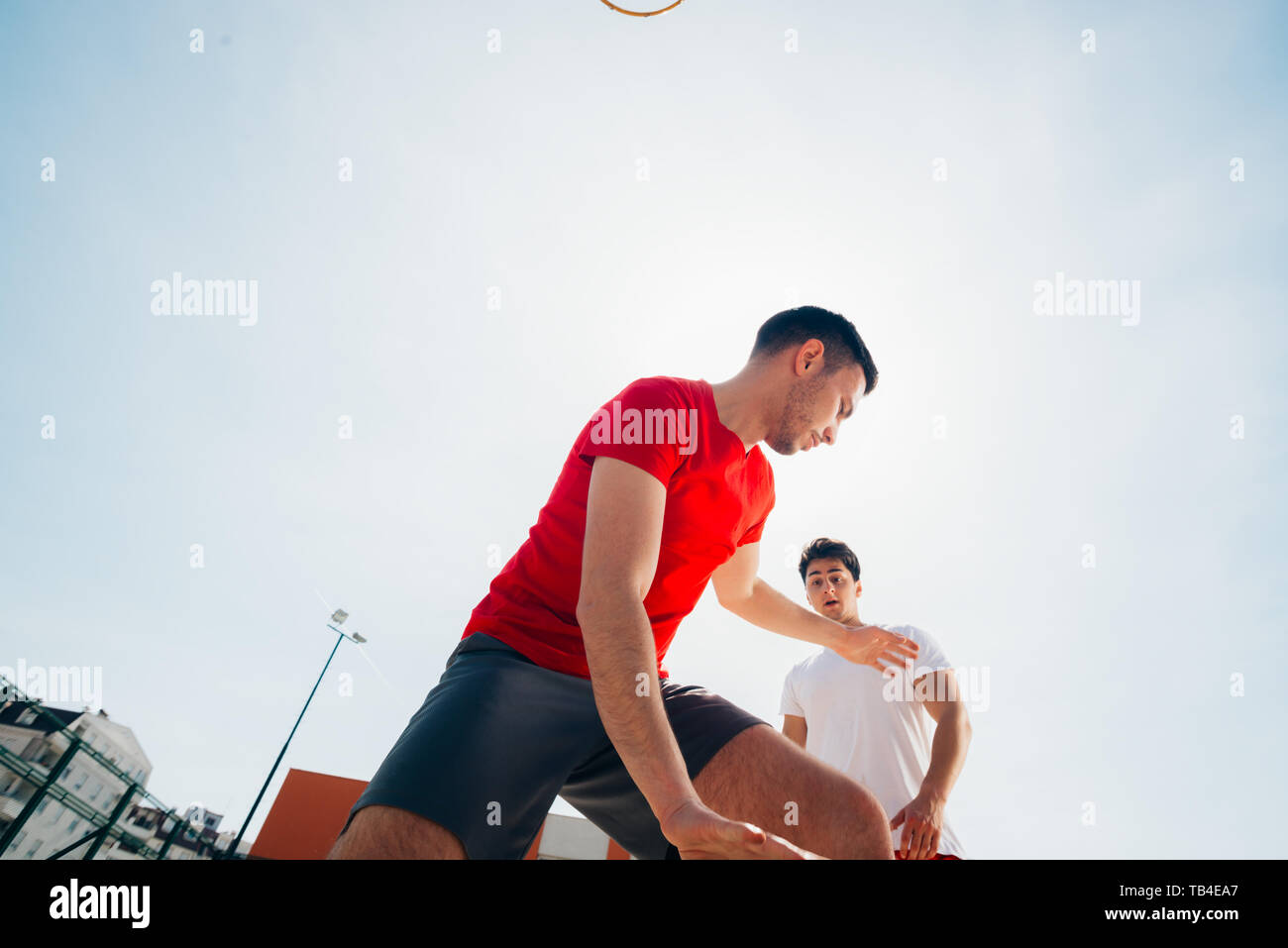 Close up portrait of two basketball players while the push each other ...