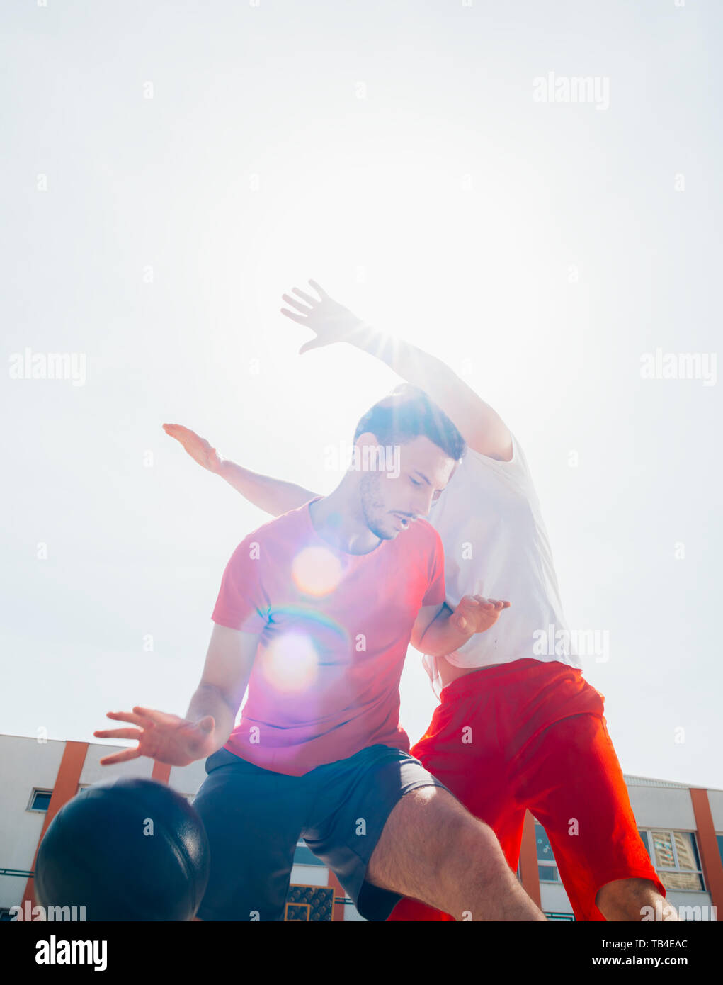 Close up portrait of two basketball players while the push each other ...