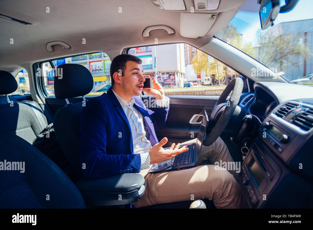 Reckless businessman driving in the city during the rush hour while ...