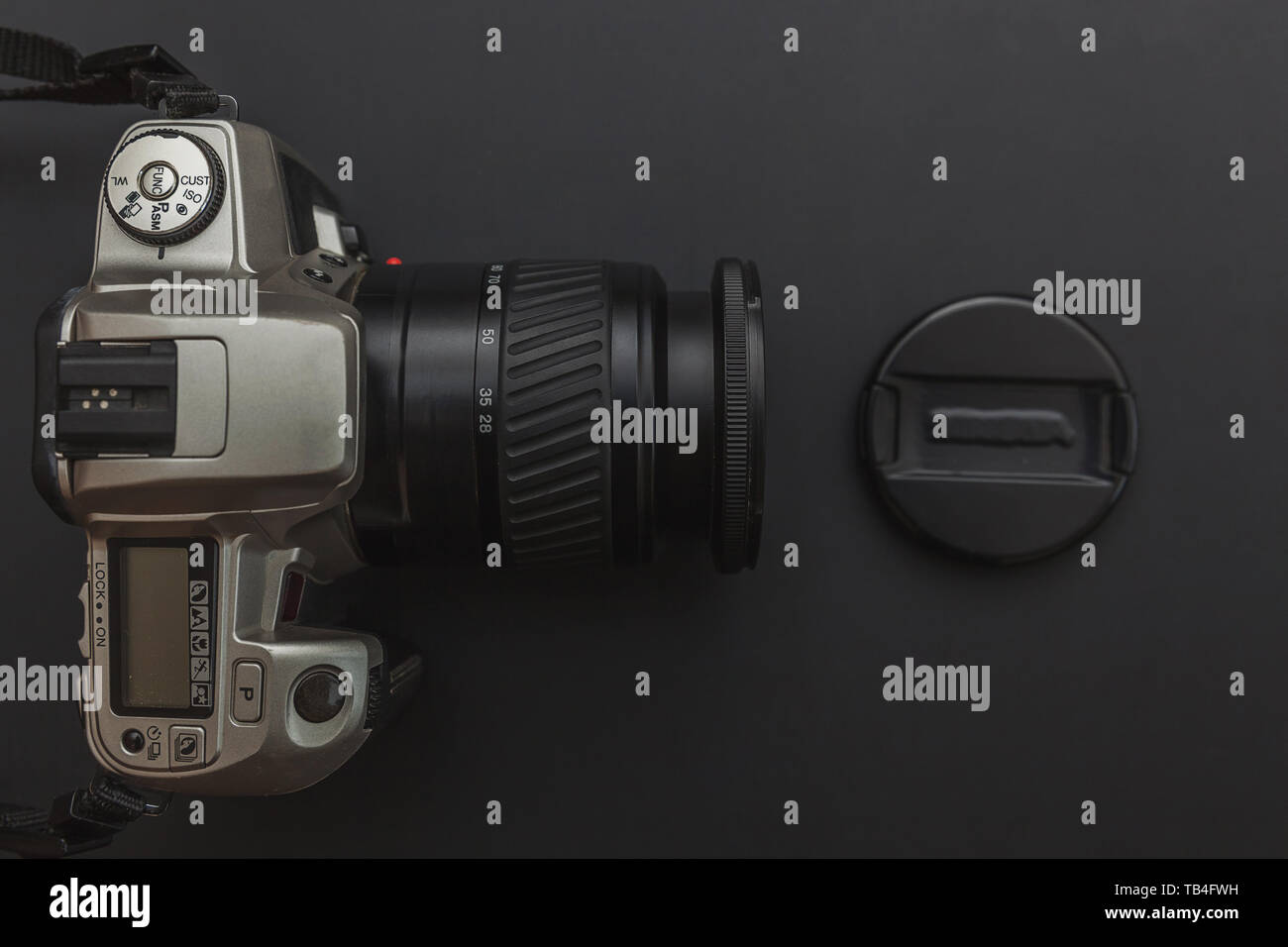 Photographer workplace with dslr camera system on dark black table ...