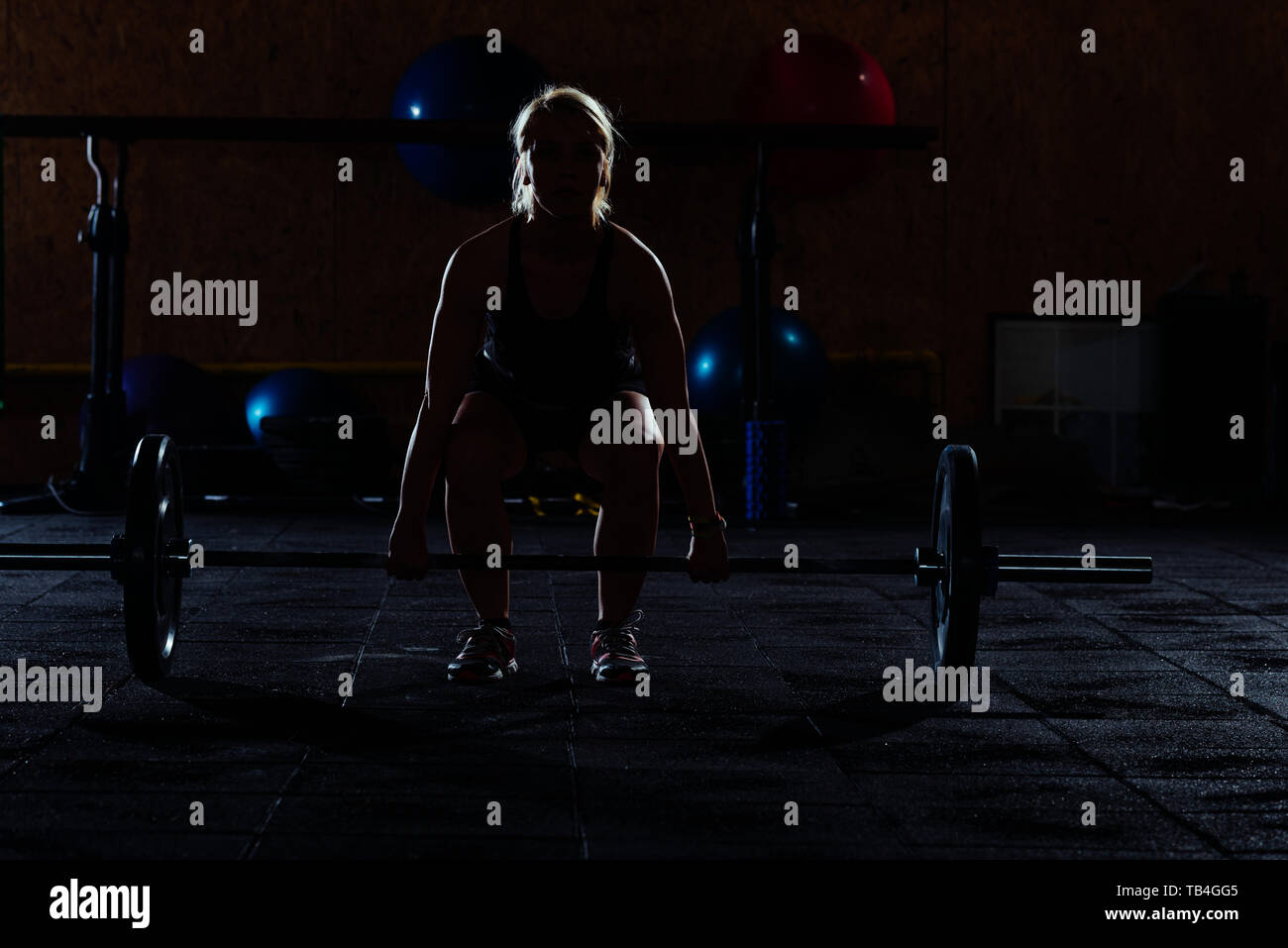 Strong girl is having gym workout routine Stock Photo - Alamy