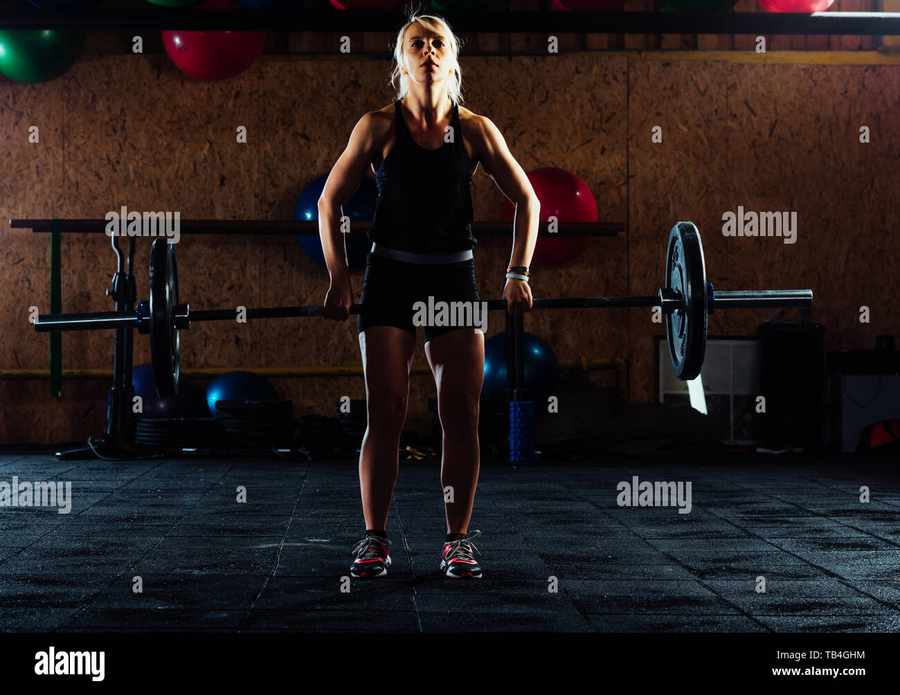 Young girl doing exercise in the gym Stock Photo - Alamy
