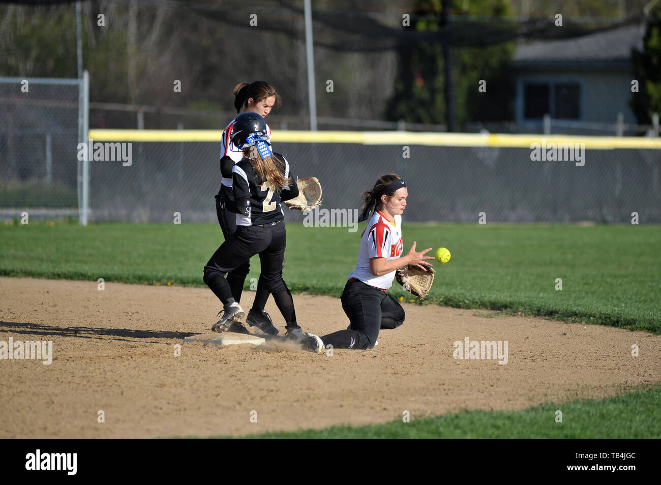 Second baseman catching a one-hop throw from an outfielder as an ...