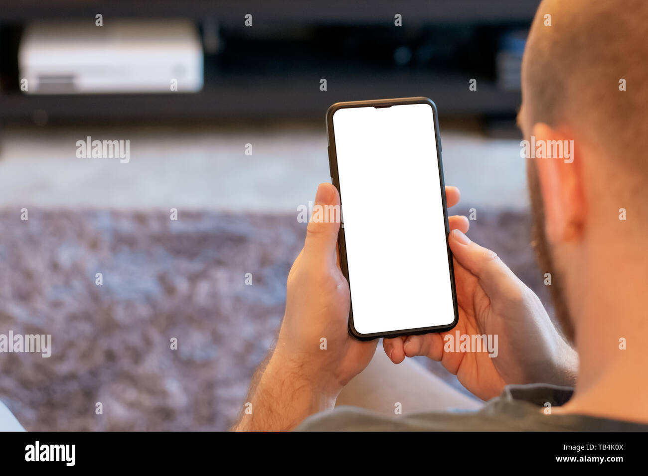 Using a mobile and watching tv hi-res stock photography and images - Alamy
