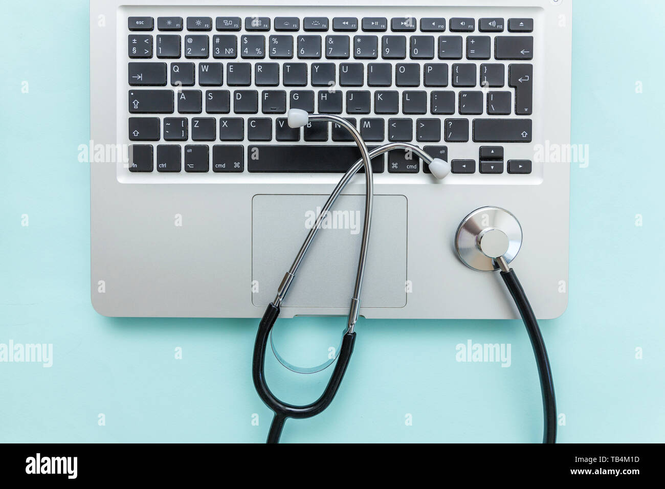 Stethoscope keyboard laptop computer isolated on blue background ...