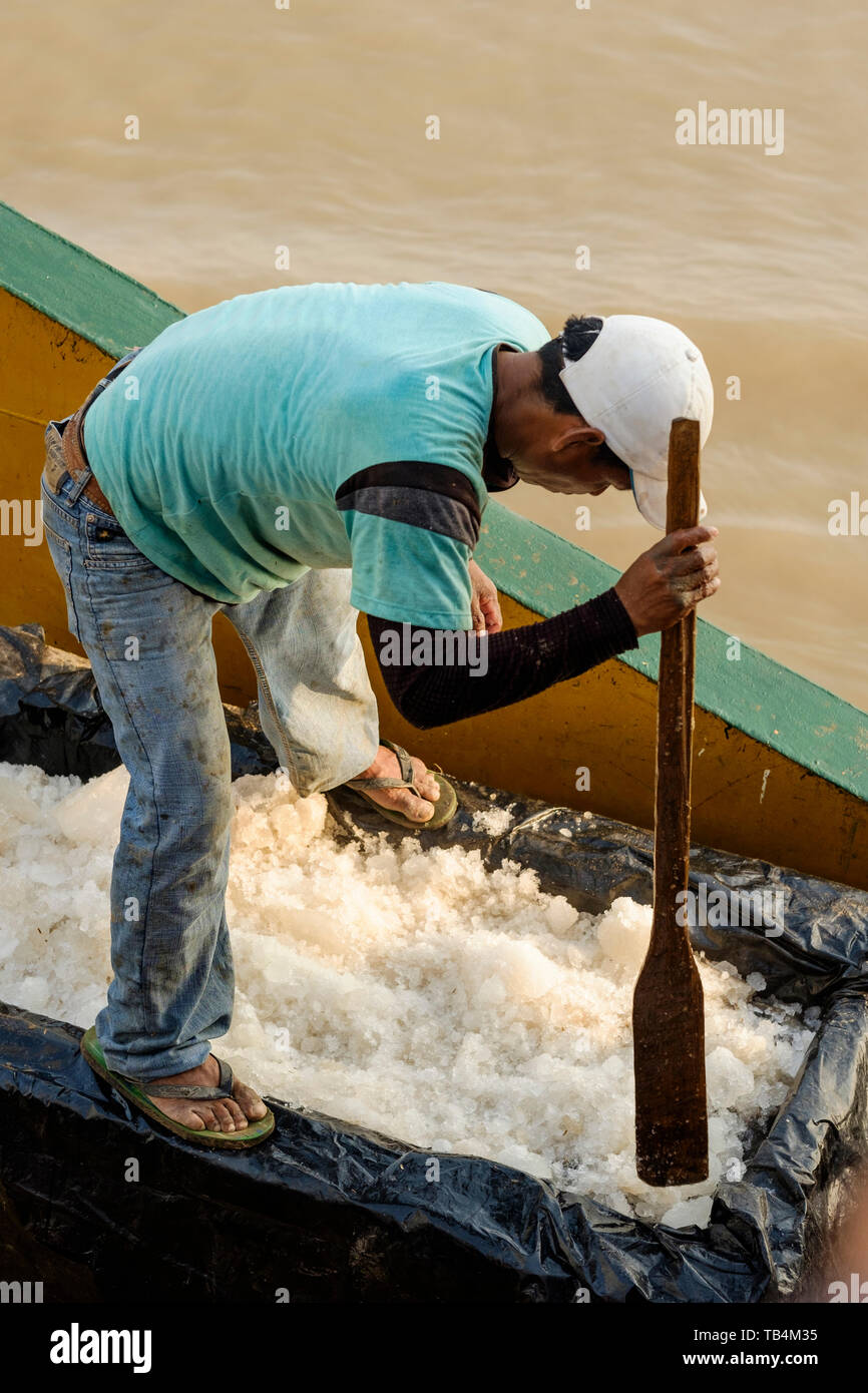 Local fisherman fixing the ice for his fish cargo at ferry Iquitos ...