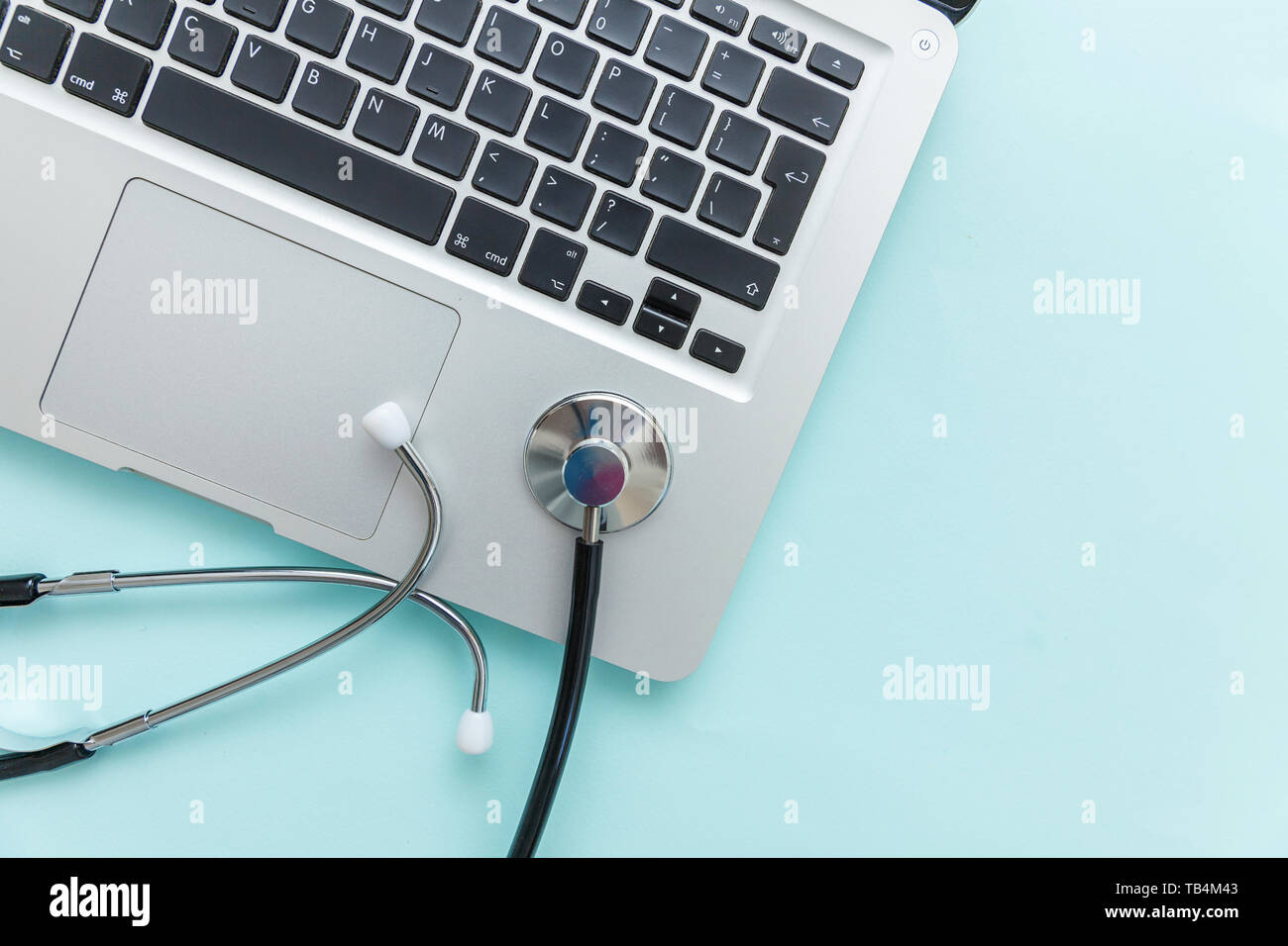 Stethoscope keyboard laptop computer isolated on blue background ...