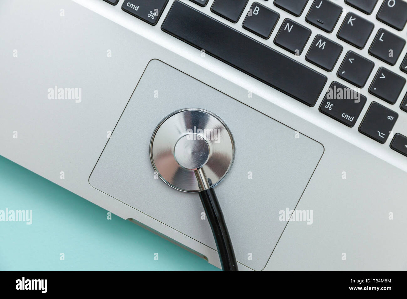 Stethoscope keyboard laptop computer isolated on blue background ...