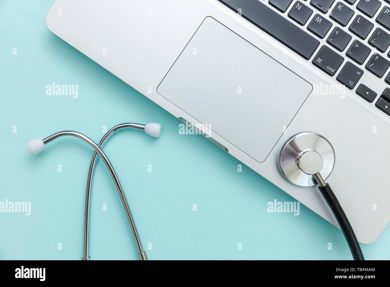 Stethoscope keyboard laptop computer isolated on blue background ...