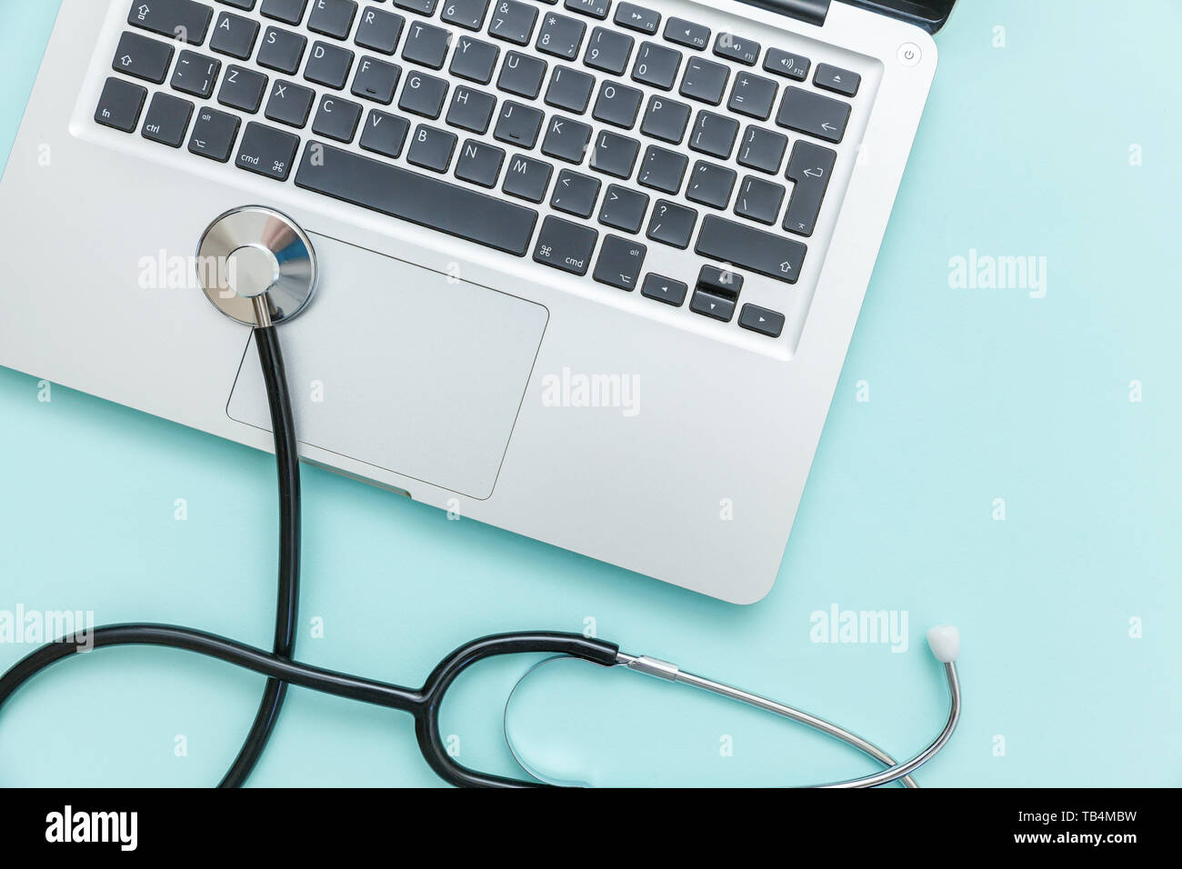 Stethoscope keyboard laptop computer isolated on blue background ...