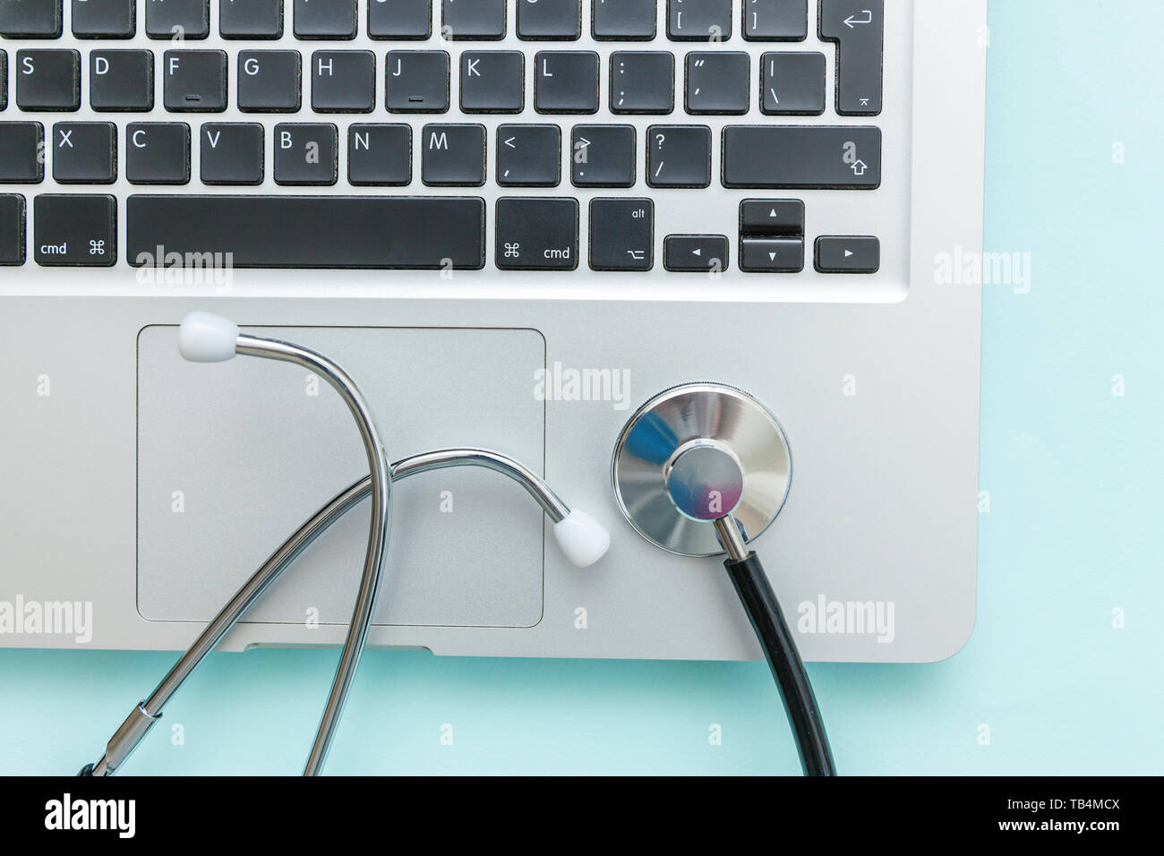 Stethoscope keyboard laptop computer isolated on blue background ...