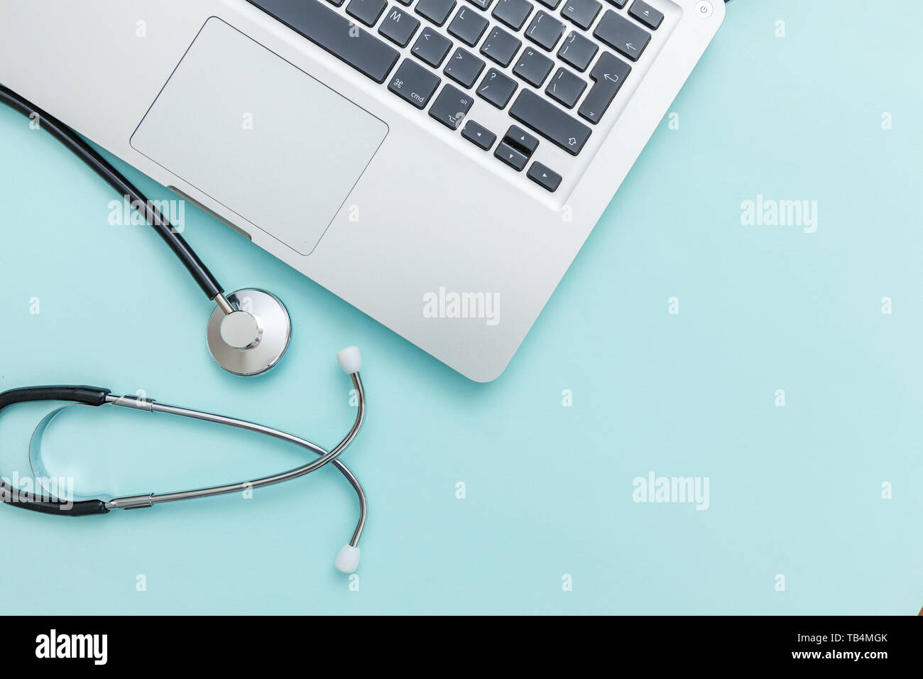 Stethoscope keyboard laptop computer isolated on blue background ...