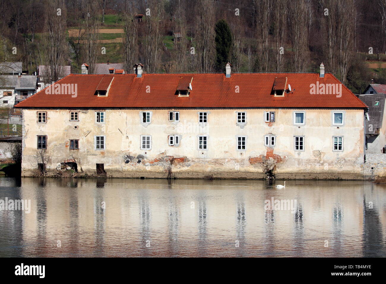 Elongated old dilapidated apartment building with cracked facade and ...
