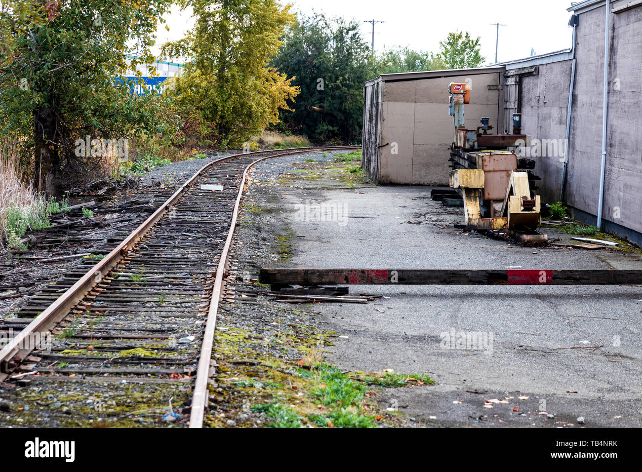 Old mechanic garage building with equipment and railroad tracks in ...
