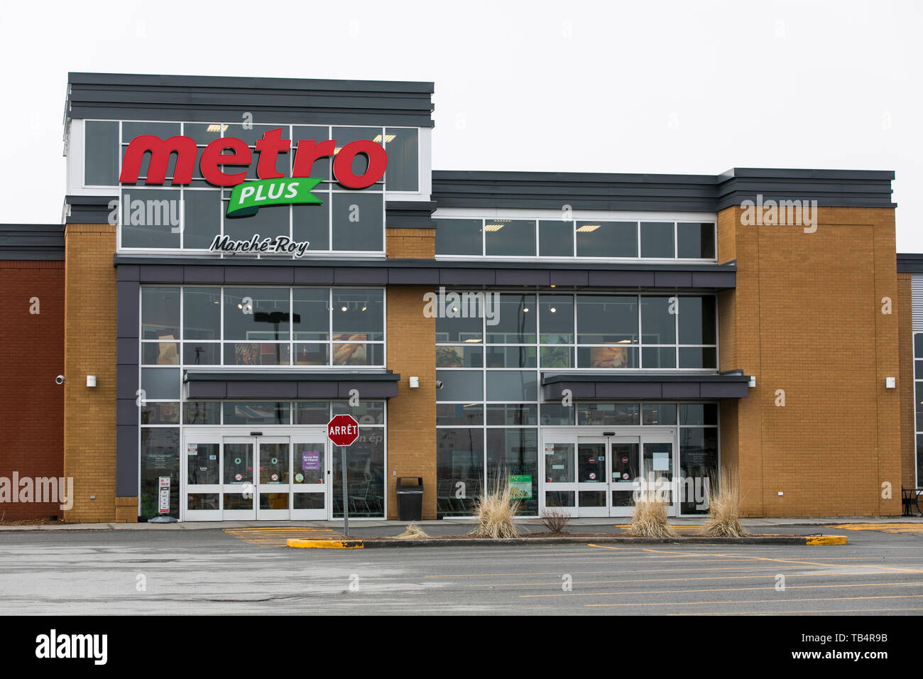 A logo sign outside of a Metro Plus retail grocery store location in ...