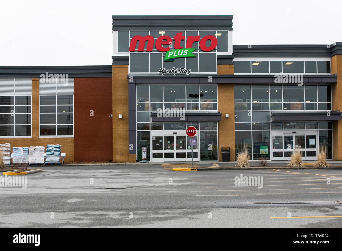 A logo sign outside of a Metro Plus retail grocery store location in ...