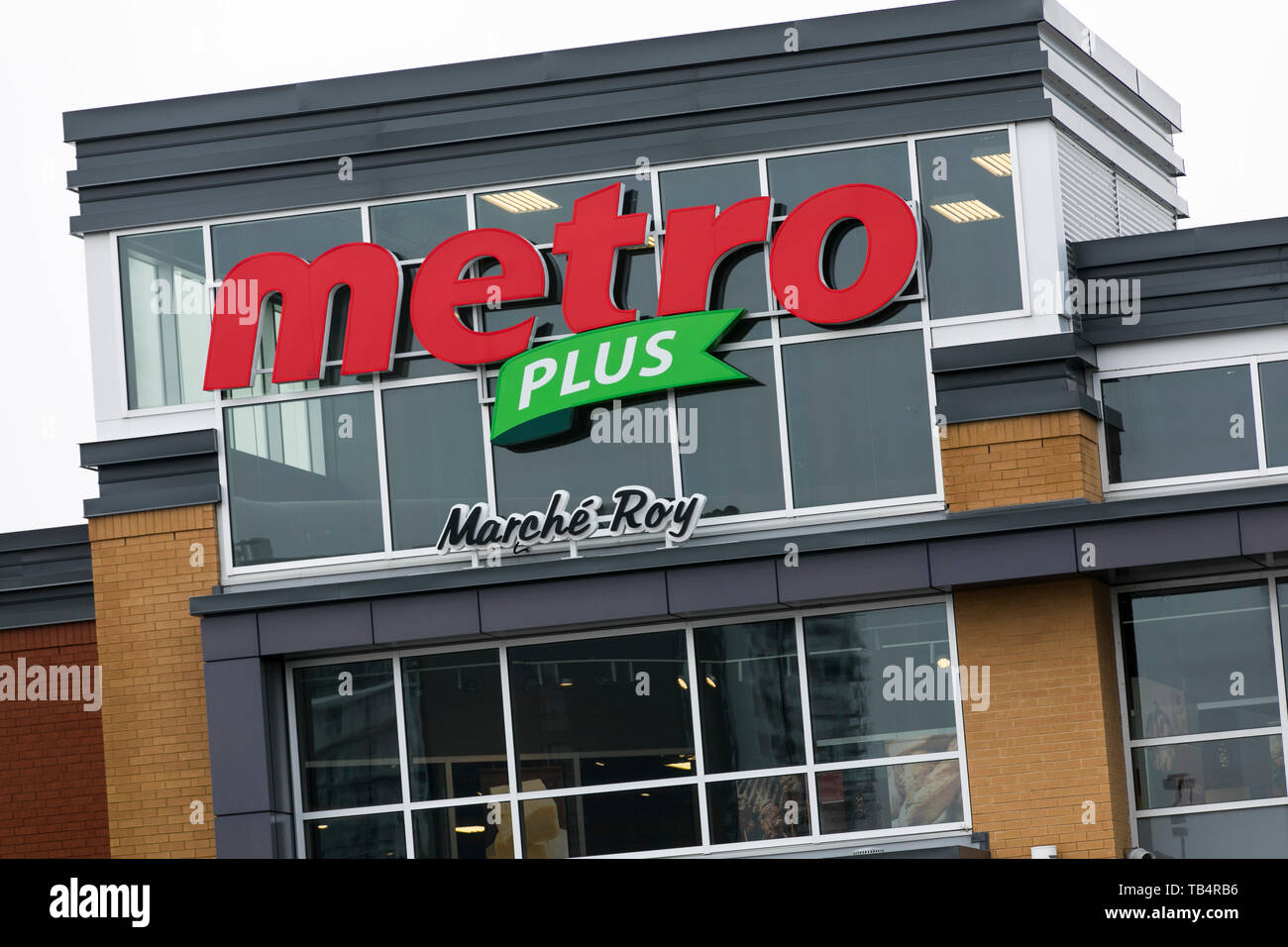 A logo sign outside of a Metro Plus retail grocery store location in ...