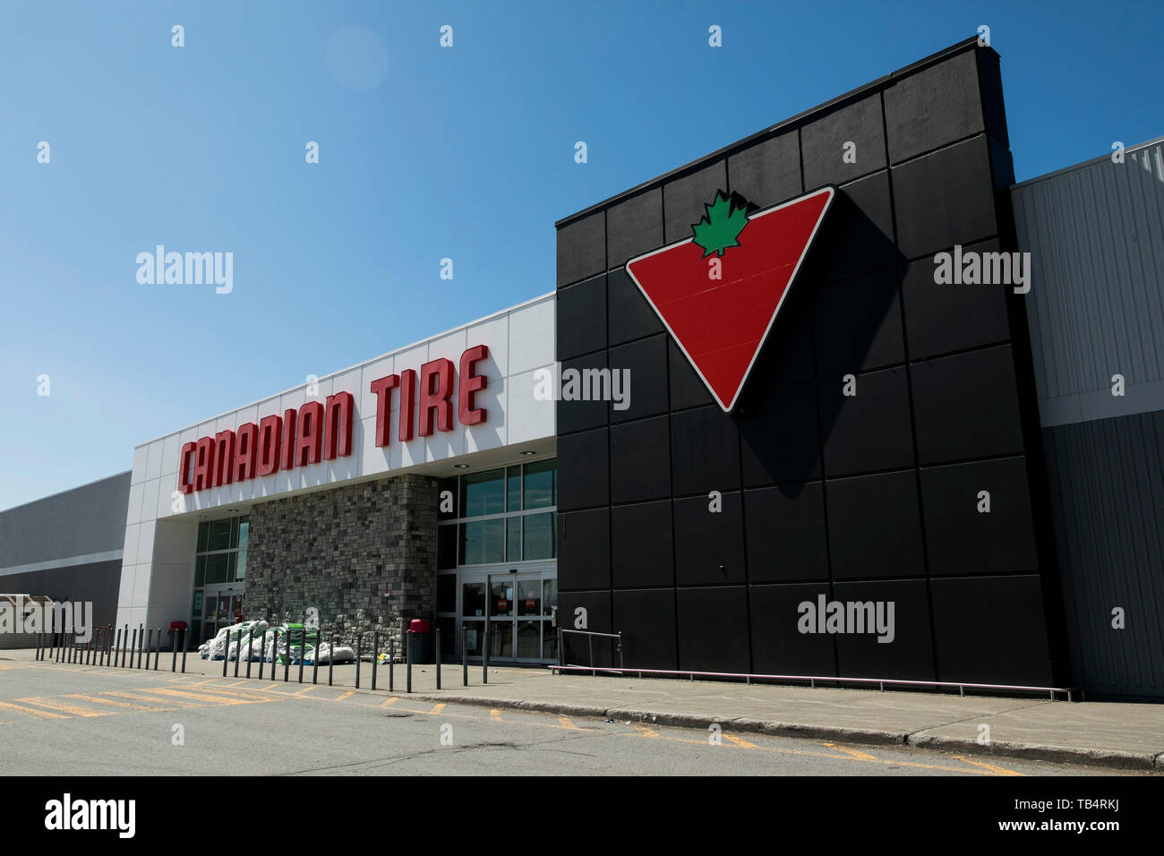A logo sign outside of a Canadian Tire retail store location in ...