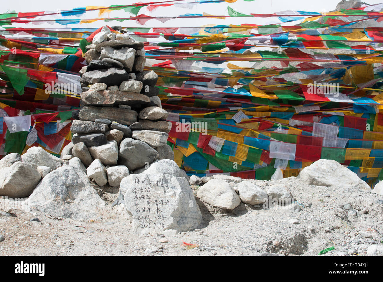 Prayer flags and stones Stock Photo - Alamy