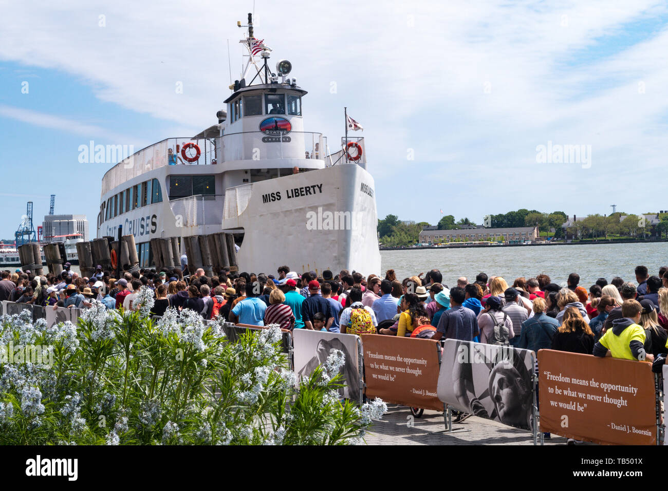 Tourists wait in line to board the Statue of Liberty Ferry in Battery ...