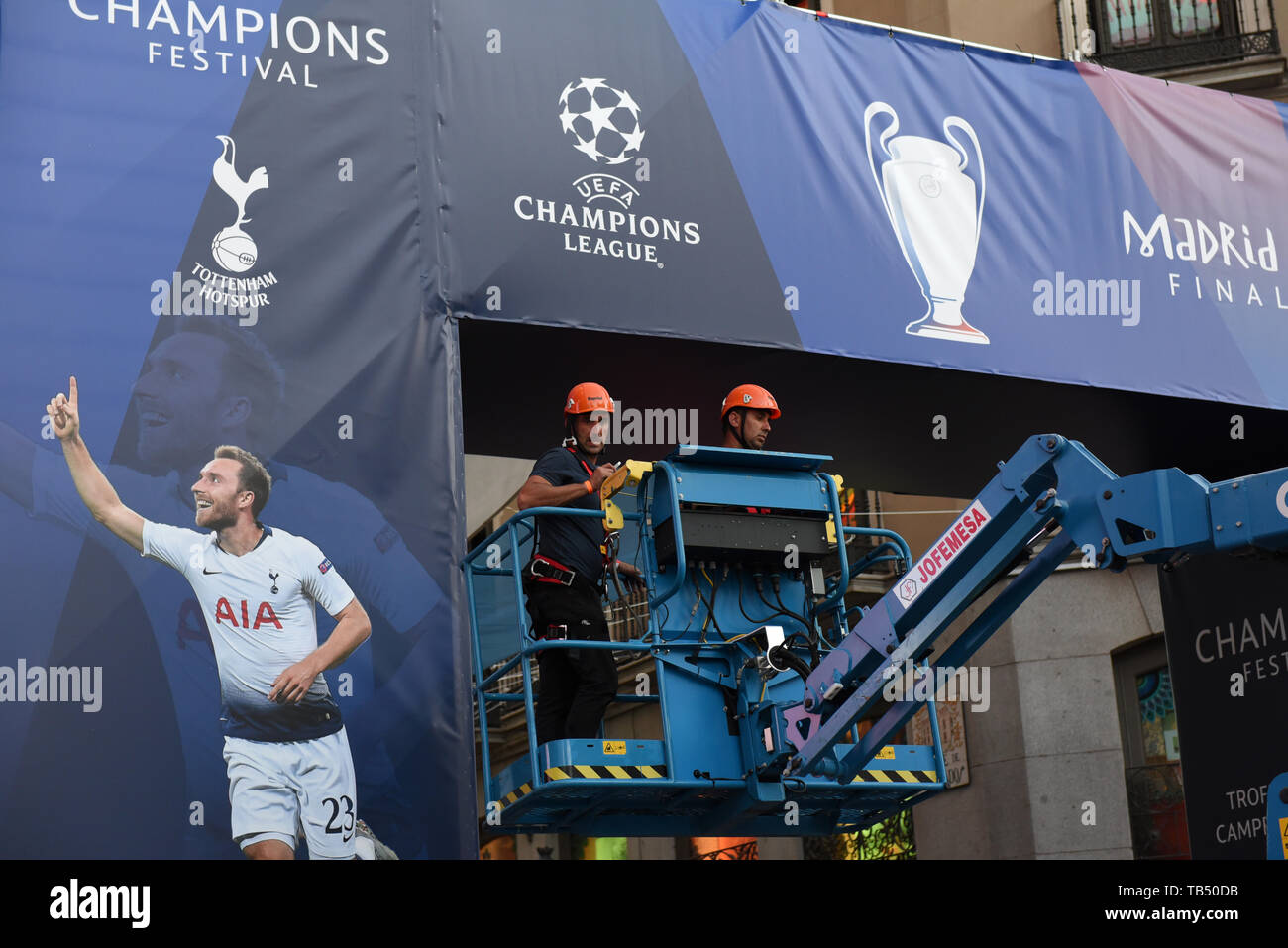 Workers putting on a giant advertisement of the 2019 Champions League ...