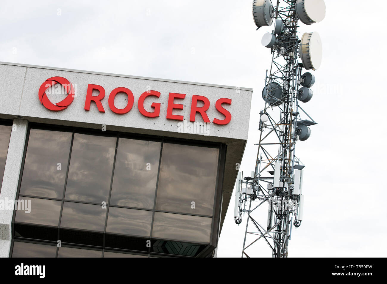 A logo sign outside of a facility occupied by Rogers Communications in ...