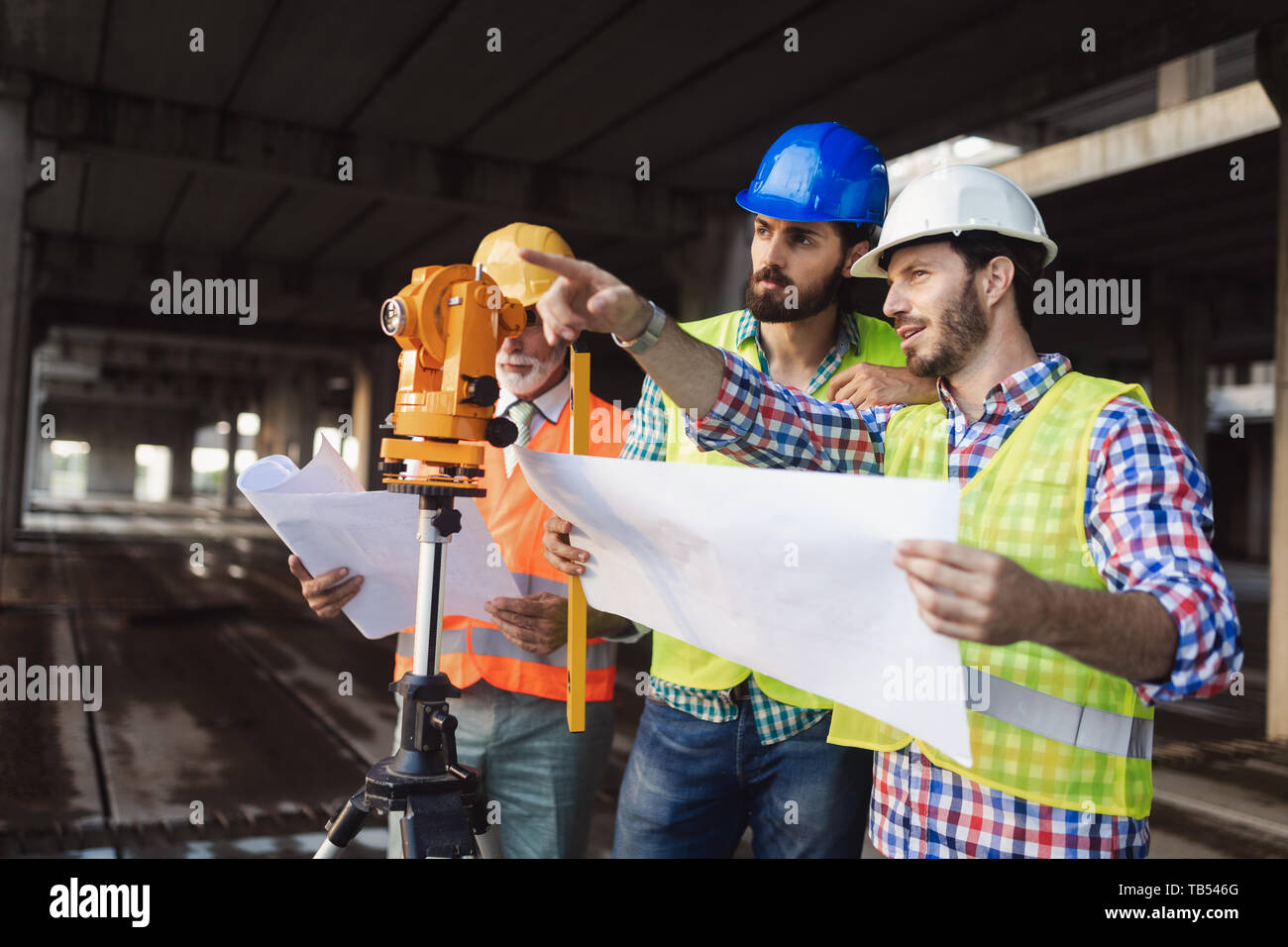 Construction engineers discussion with architects at construction or ...