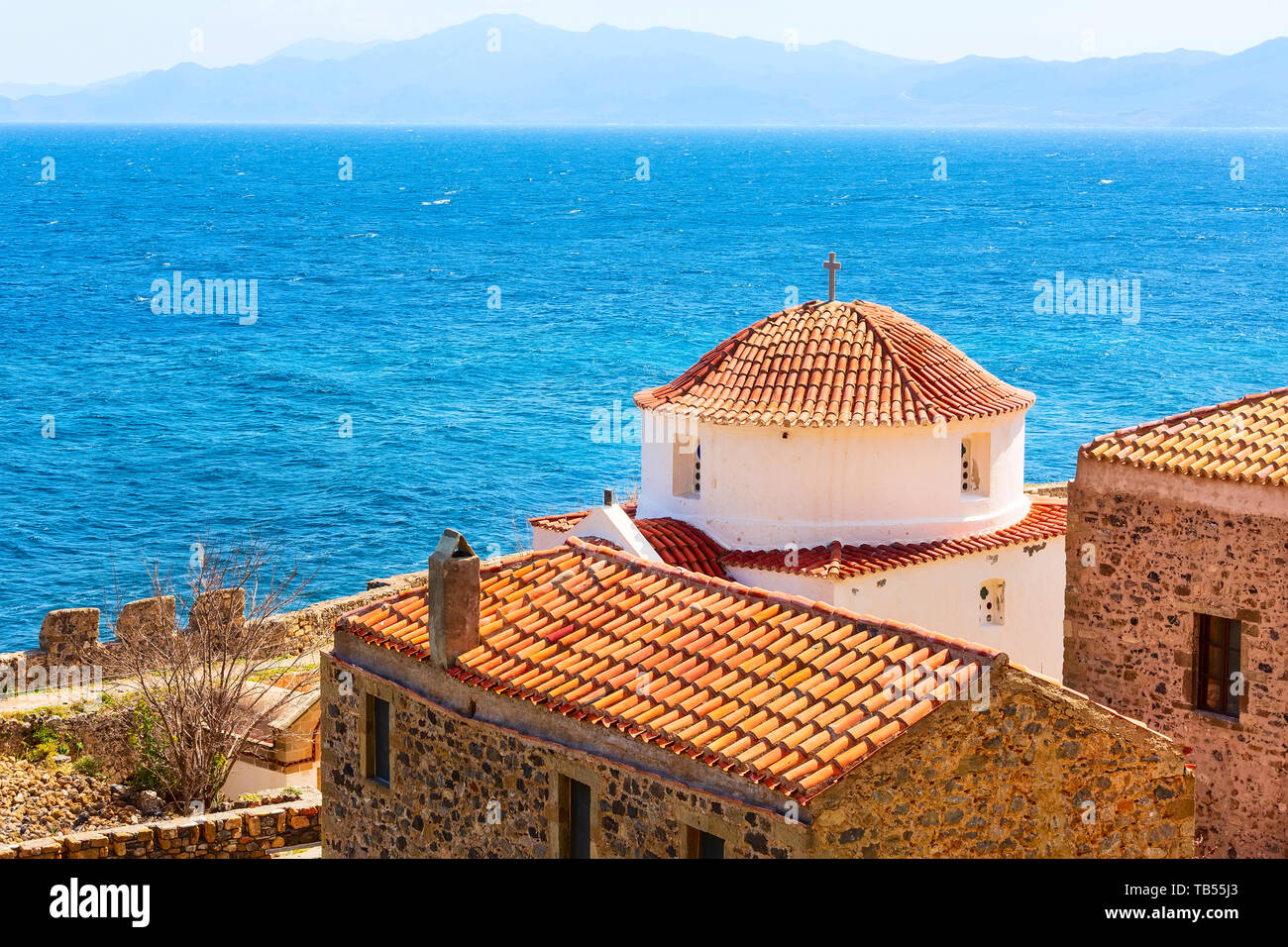 Monemvasia church, old red brick houses, roofs in ancient town and blue ...