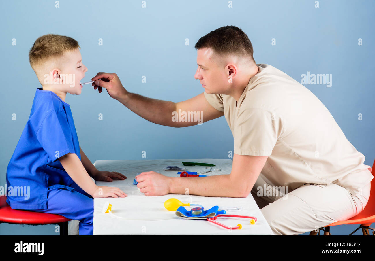Medical service. Man doctor sit table medical tools examining little ...