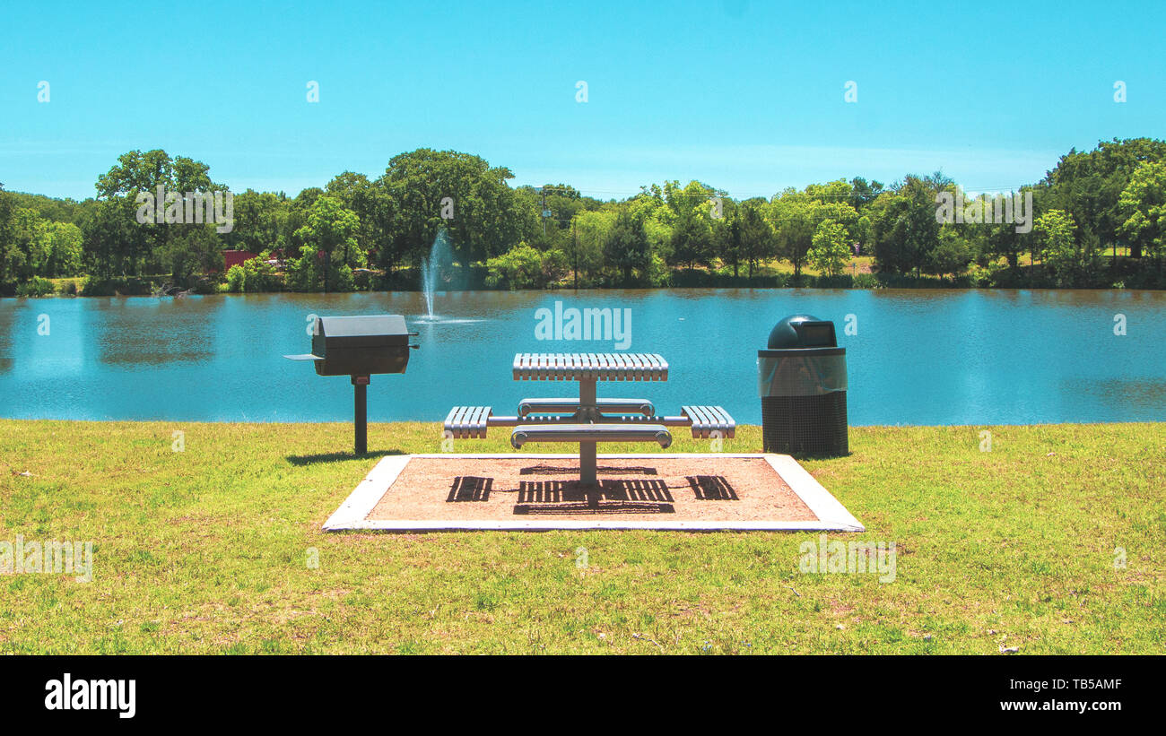 local park, lake view, bench with bbq stove and garbage can Stock Photo ...