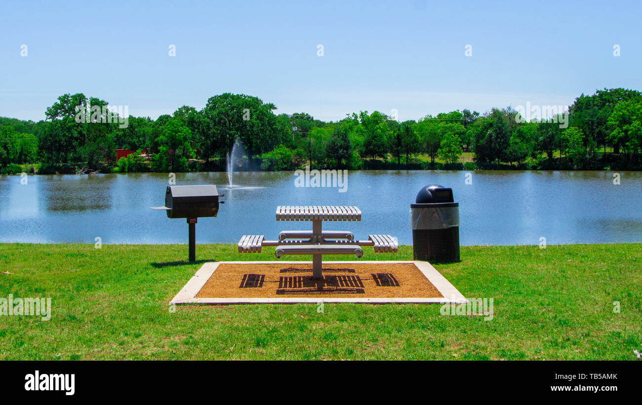 local park, lake view, bench with bbq stove and garbage can Stock Photo ...