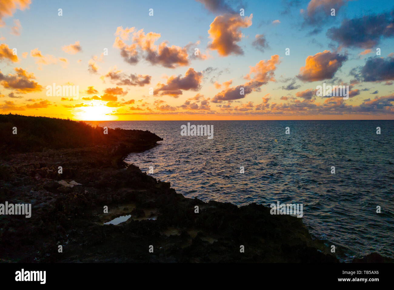 the sun hiding itself from the horizontal line formed between the sea ...