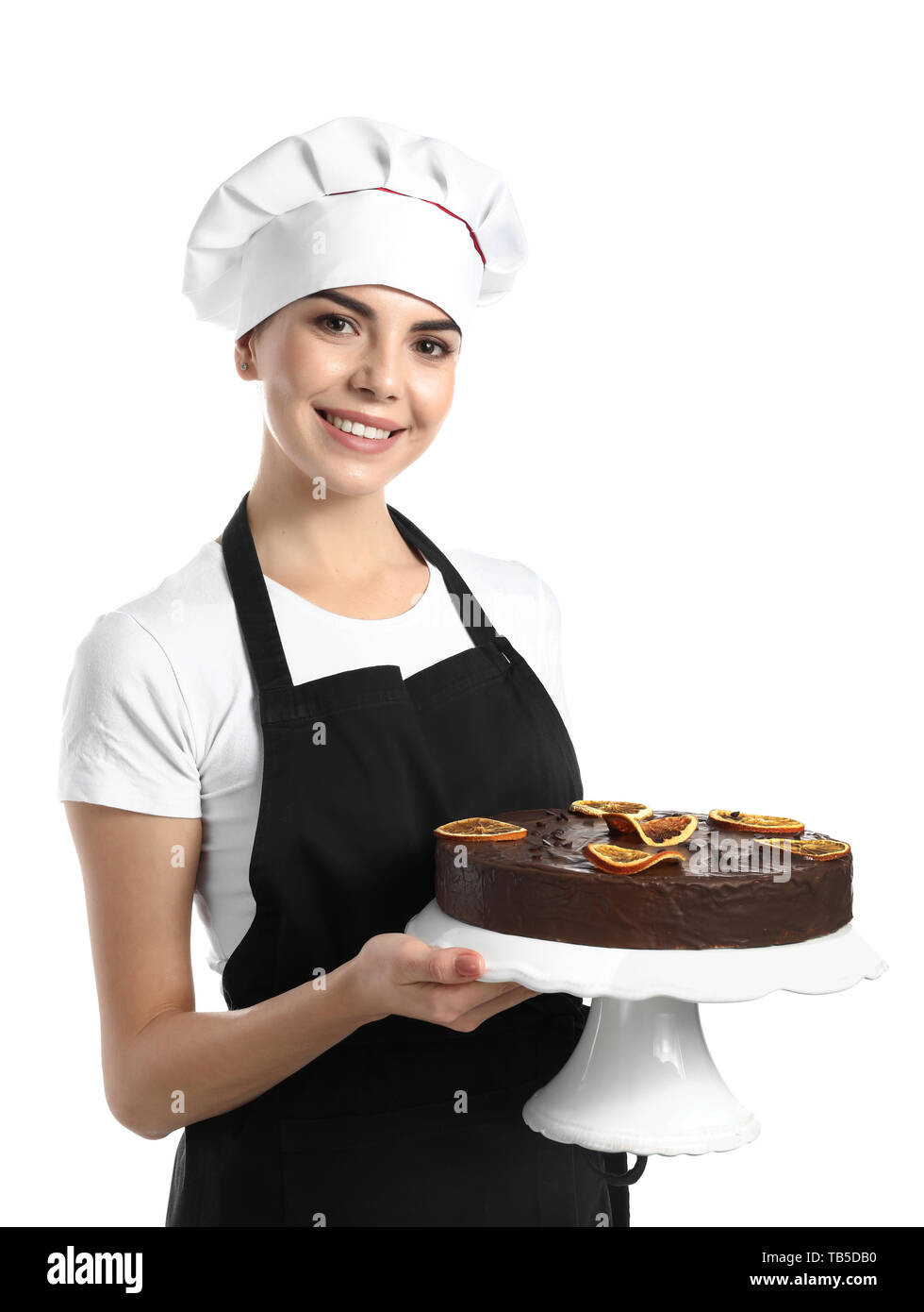 Young female confectioner with tasty cake on white background Stock ...