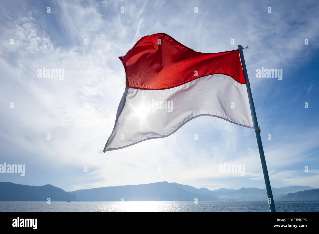Indonesian flag waving over Lake Toba and Samosir Island, Sumatra ...