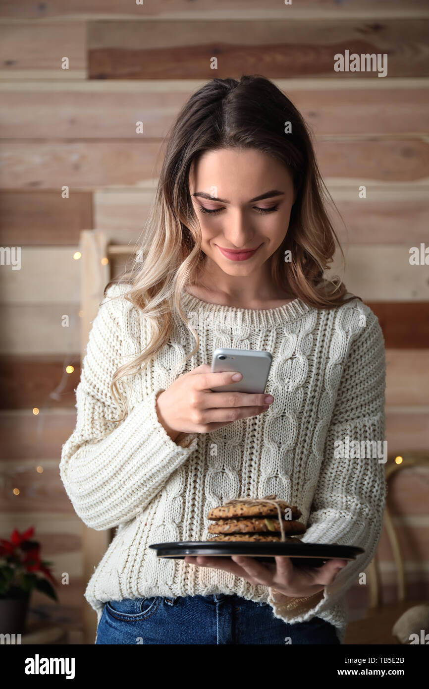 Female food photographer with mobile phone taking picture of tasty ...
