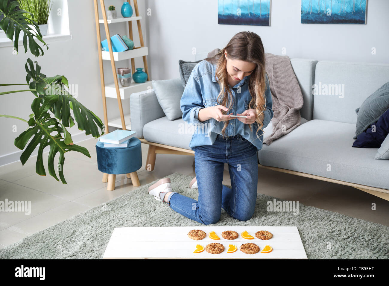 Female food photographer with mobile phone taking picture of tasty ...