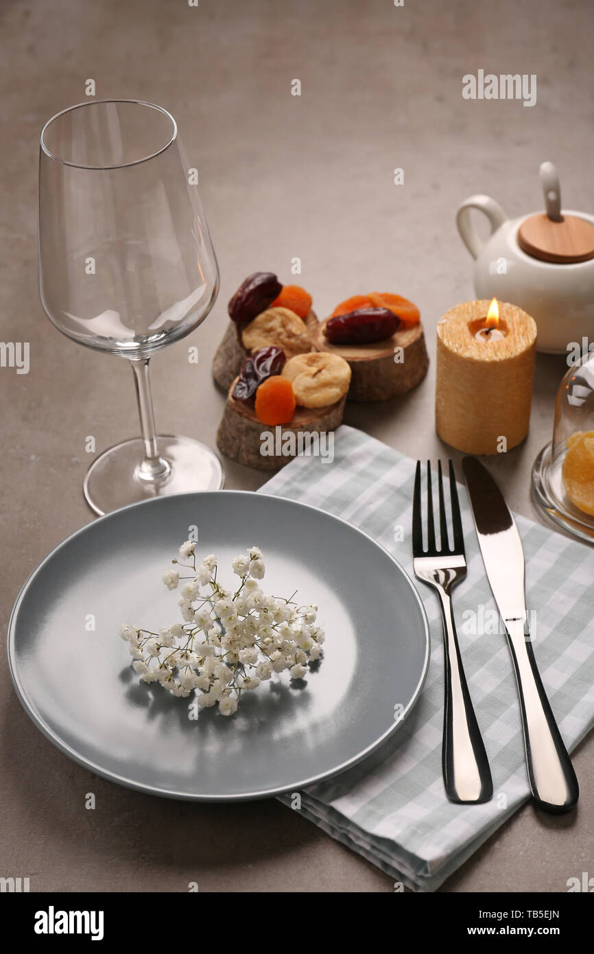 Beautiful table setting on grey background Stock Photo - Alamy