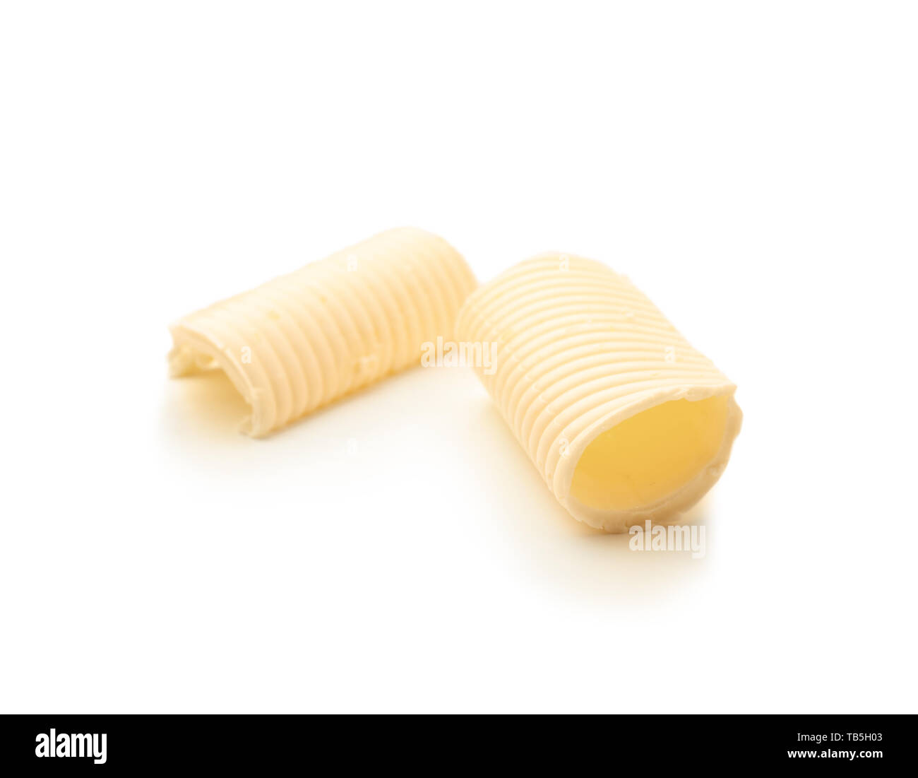 Butter curls on white background Stock Photo - Alamy