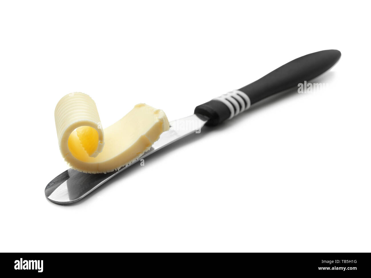 Knife with butter curl on white background Stock Photo - Alamy