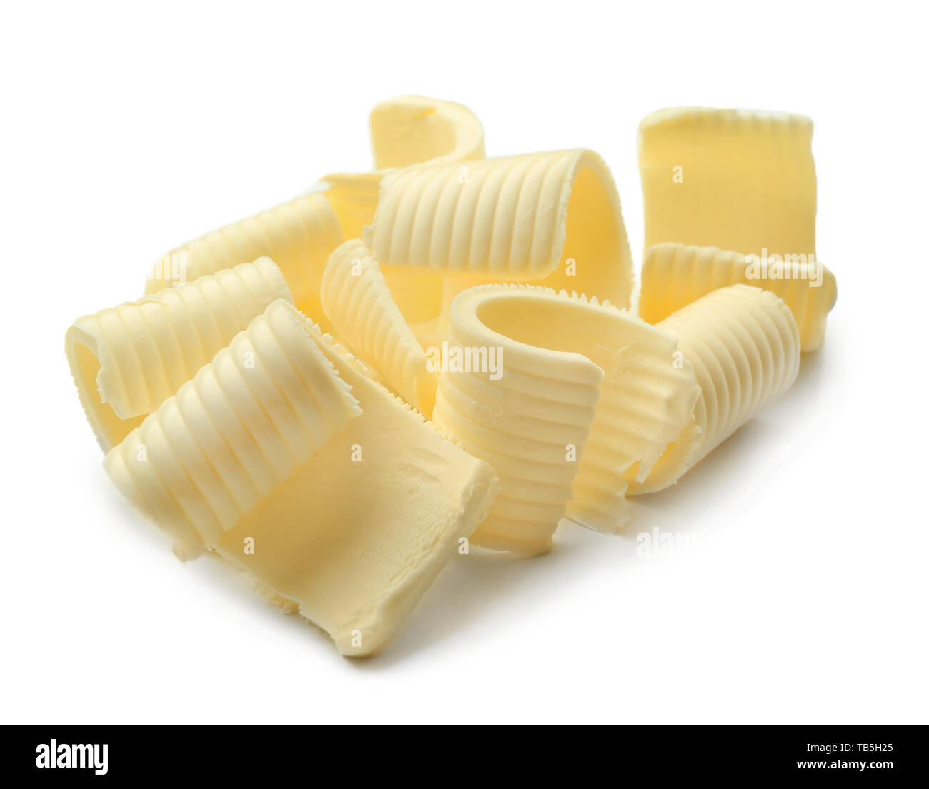 Butter curls on white background Stock Photo - Alamy