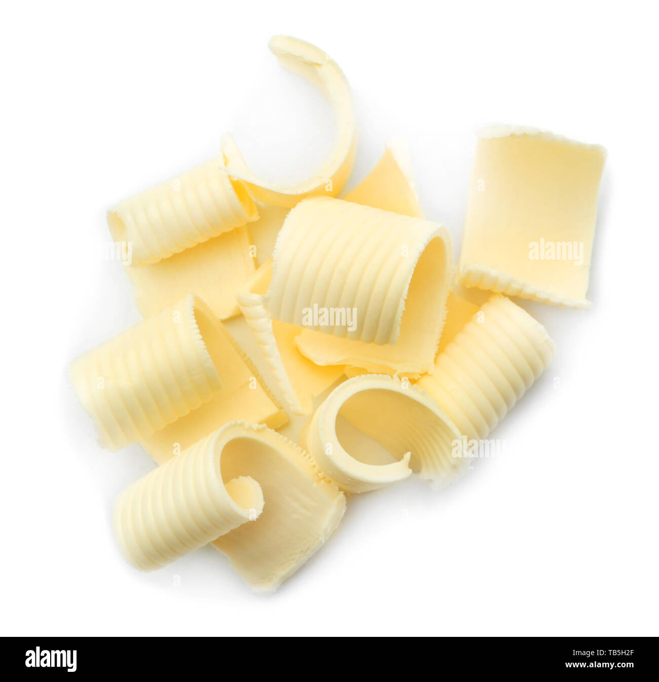 Butter curls on white background Stock Photo - Alamy