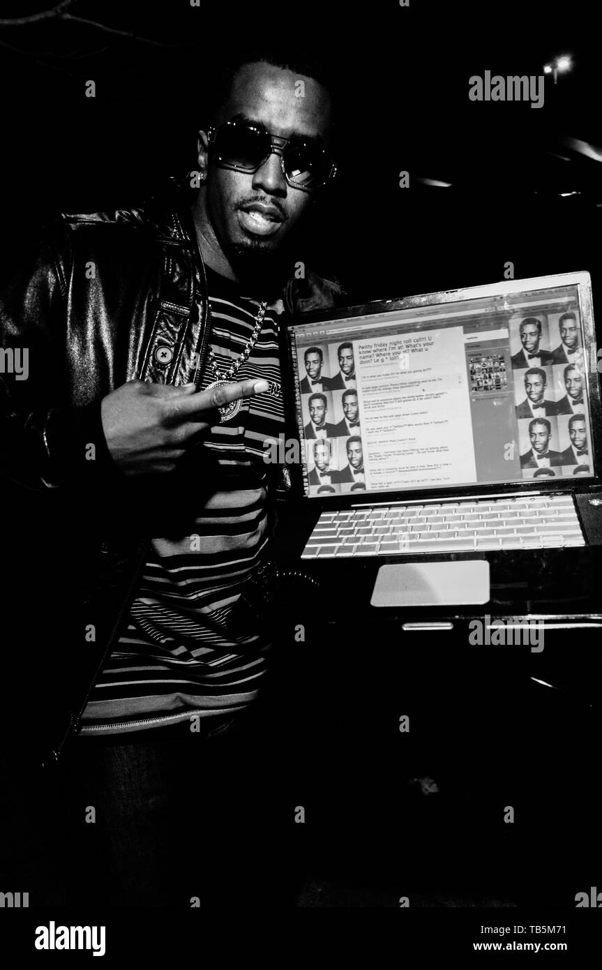 Sean Combs aka Diddy showing his Twitter page with a labtop in 2009 ...